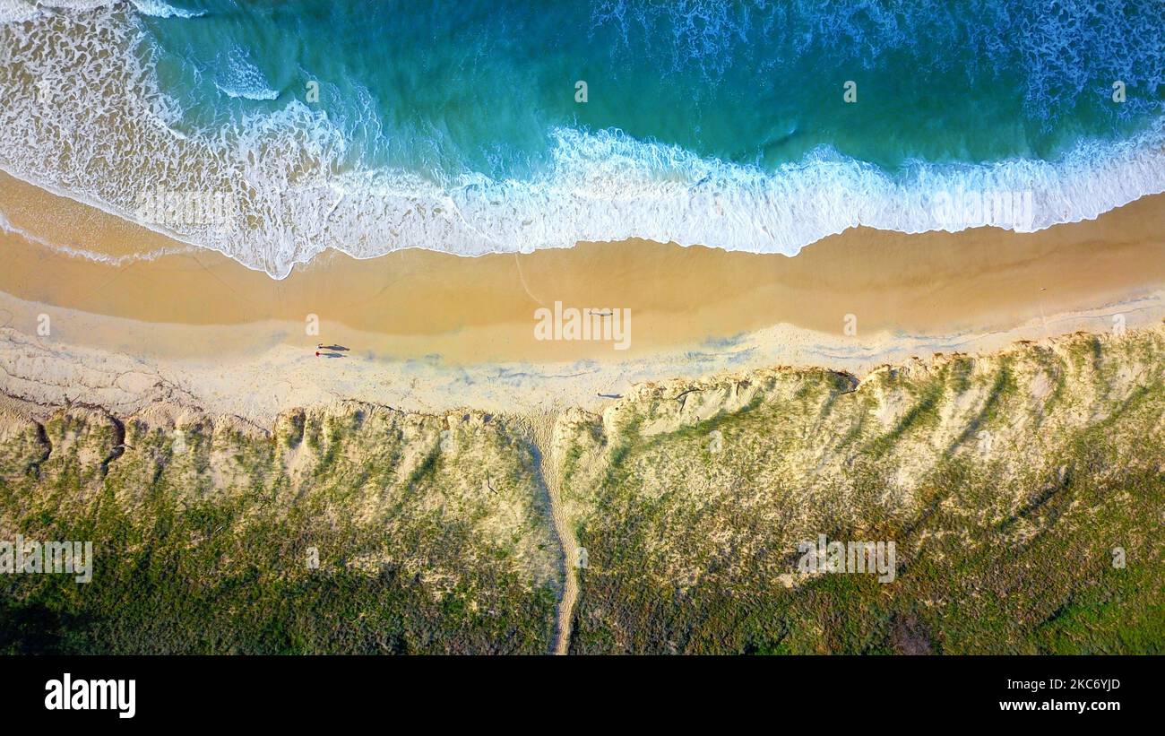 An aerial of sea waves flowing into the sandy beach Stock Photo - Alamy