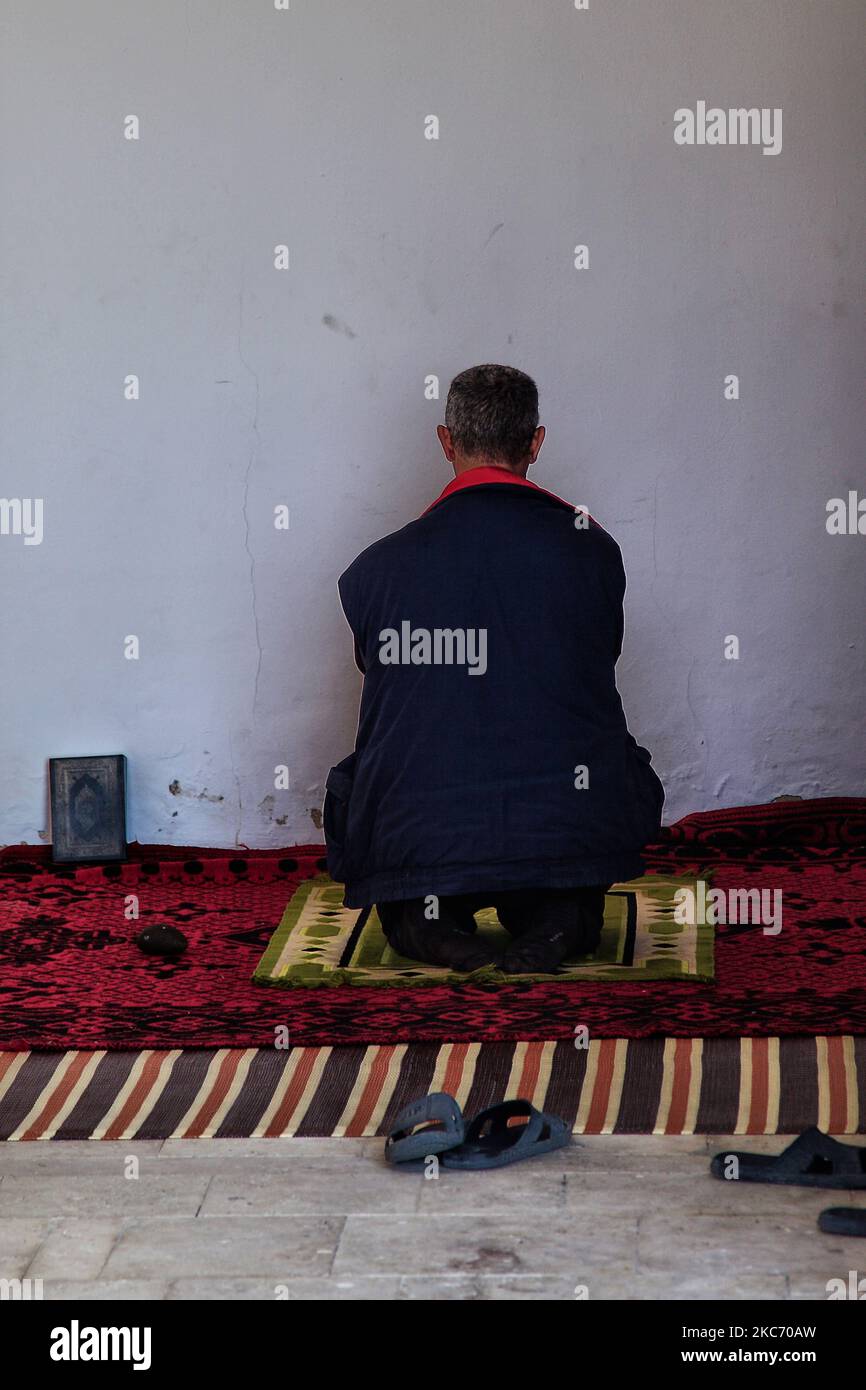 Muslim man praying in the ancient Roman town of Volubilis in Meknes ...