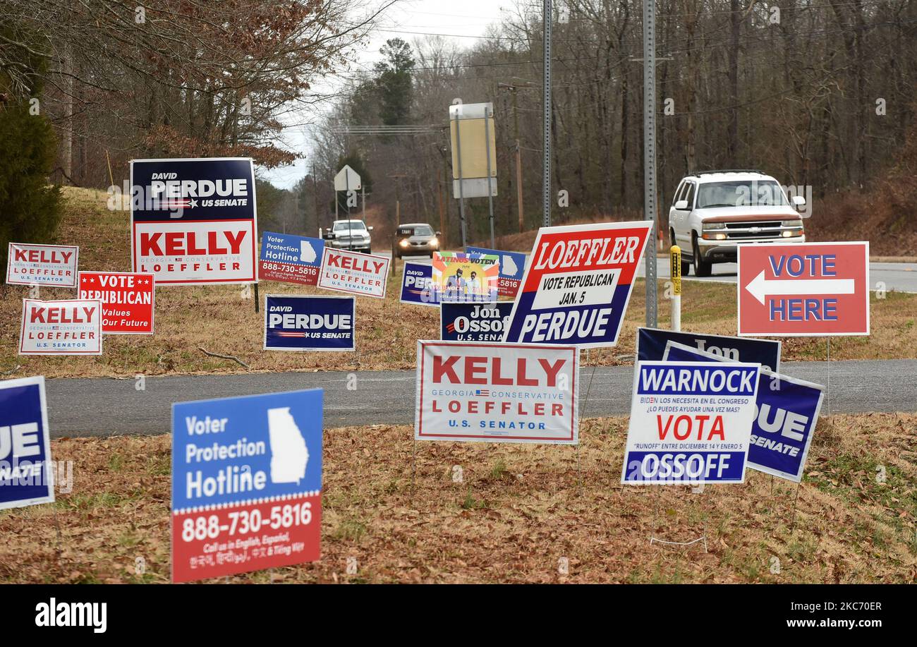 Campaign signs are seen on the highway outside a polling place at ...