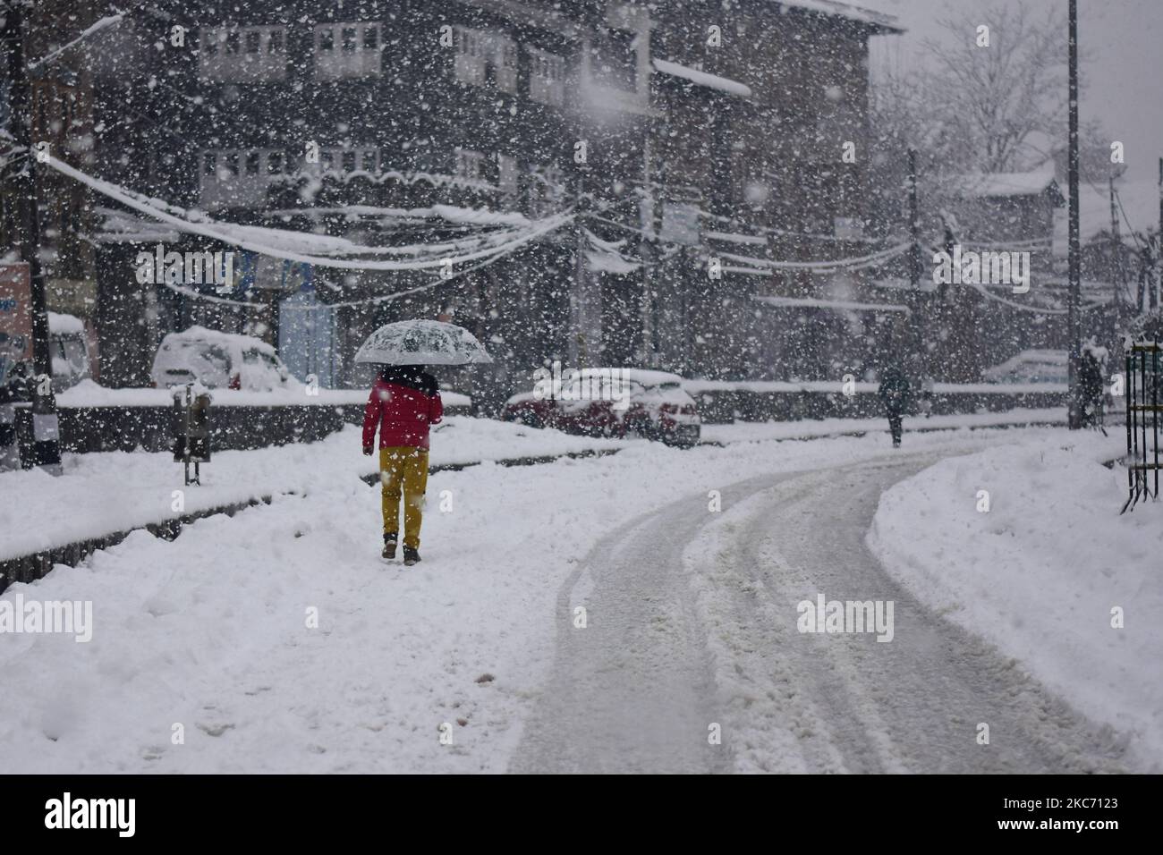 People walk amid heavy snowfall as snowfall contimues for third day in ...