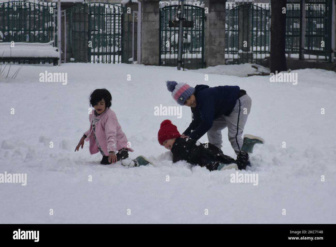 Children play in snow after heavy snowfall as snowfall contimues for ...