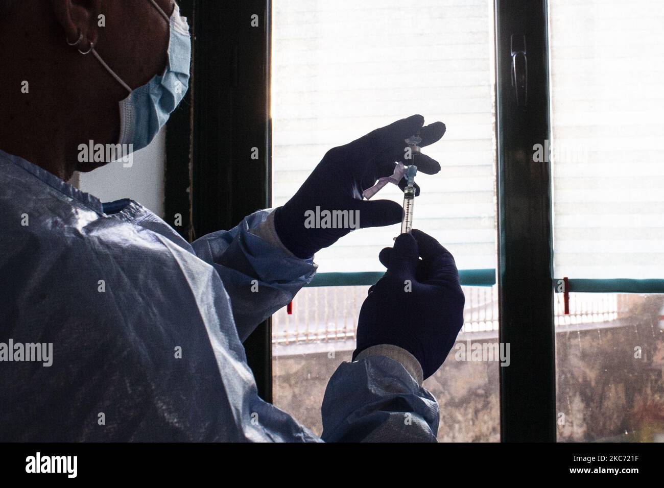 The nurse prepares another dose. Each container of the Pfizer vaccine ...