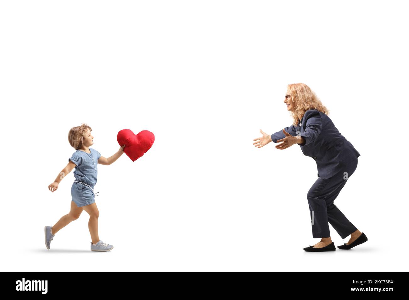 Full length profile shot of a little girl running towards a woman with ...