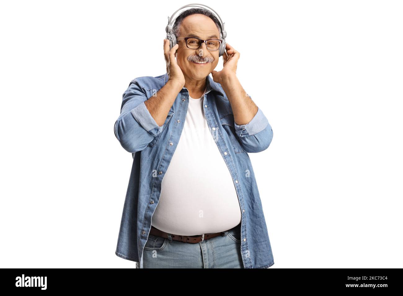Cheerful mature man with headphones listening to music isolated on ...