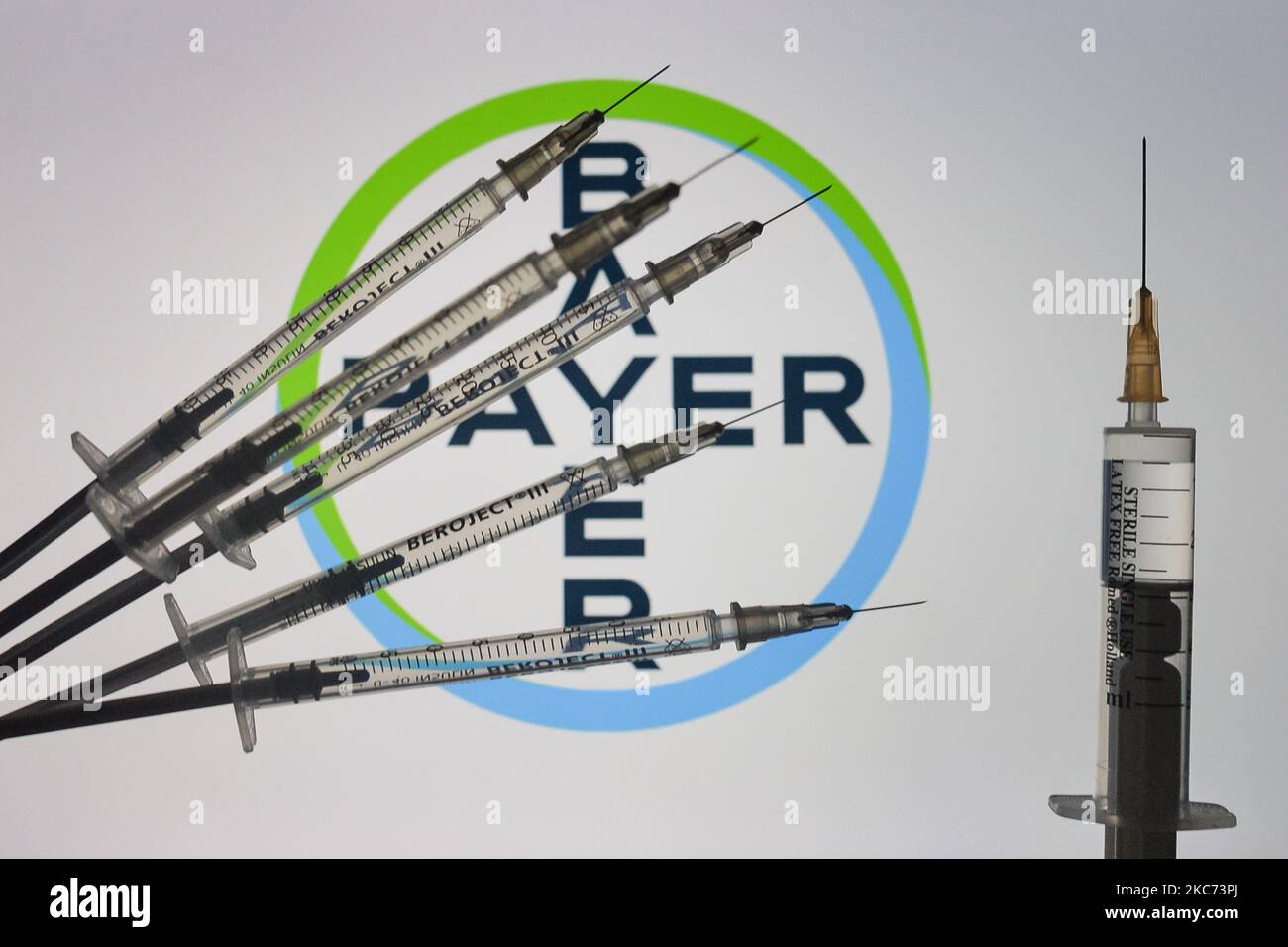 An illustrative image of medical syringes in front of Bayer logo ...