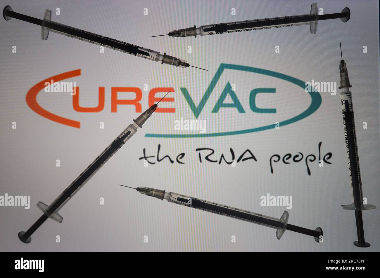 An illustrative image of medical syringes in front of CureVac logo ...