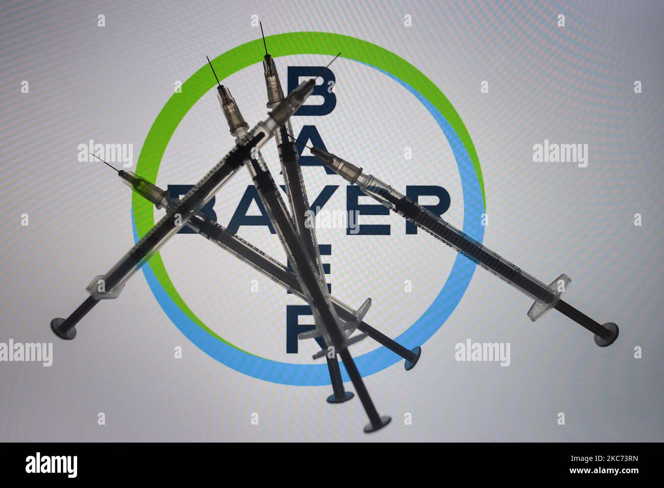 An illustrative image of medical syringes in front of Bayer logo ...