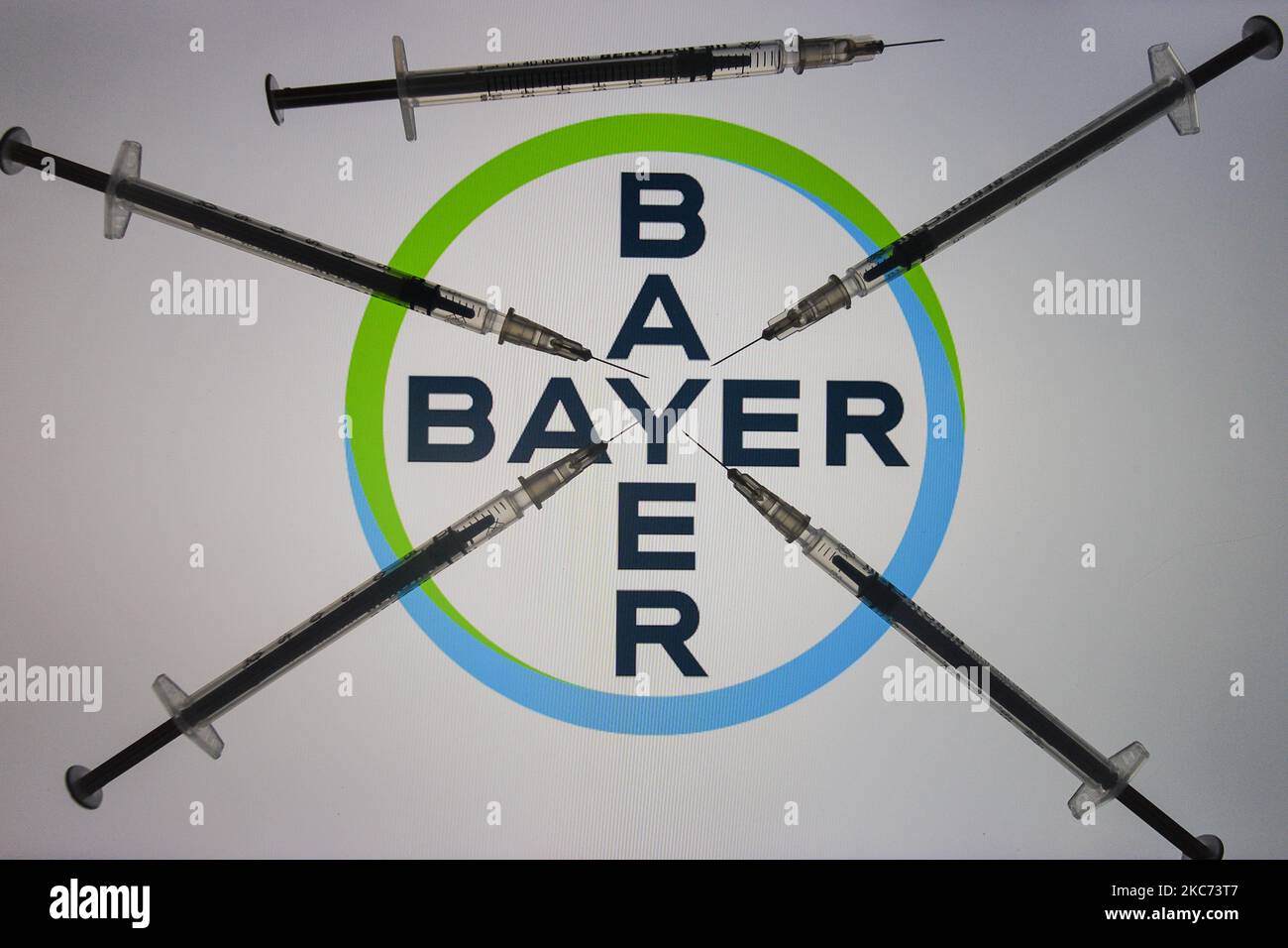 An illustrative image of medical syringes in front of Bayer logo ...