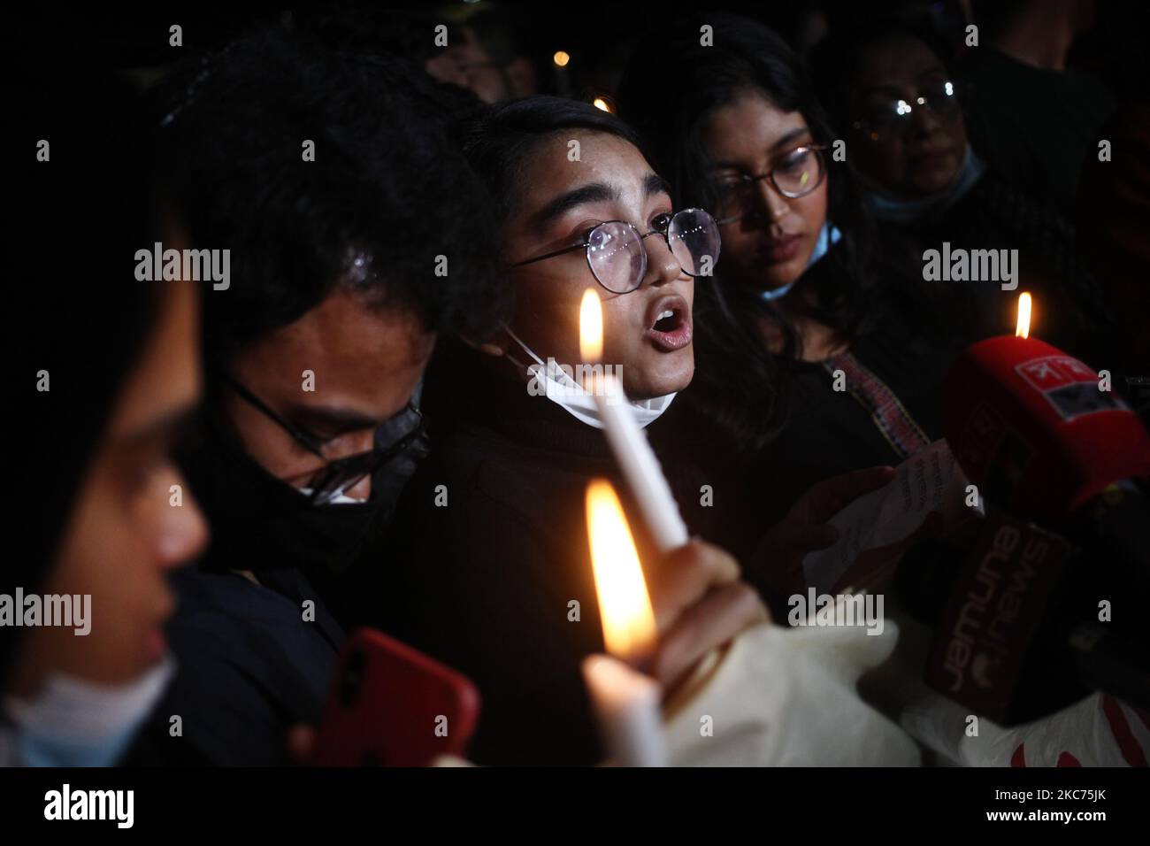 Protesters take part in a candlelight vigil as they demand justice for ...