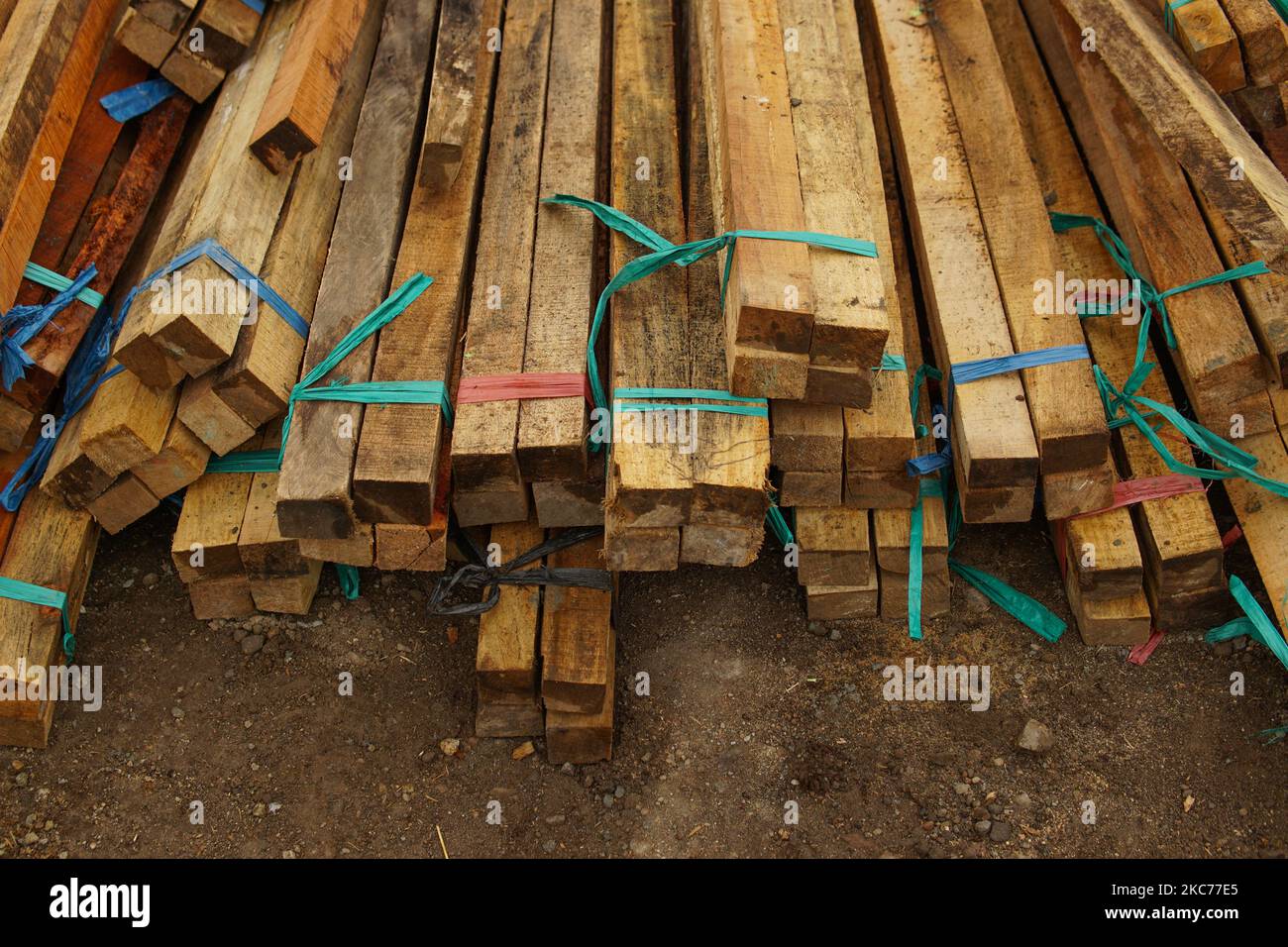A pile of wooden rafters tied with colorful raffia ropes Stock Photo ...