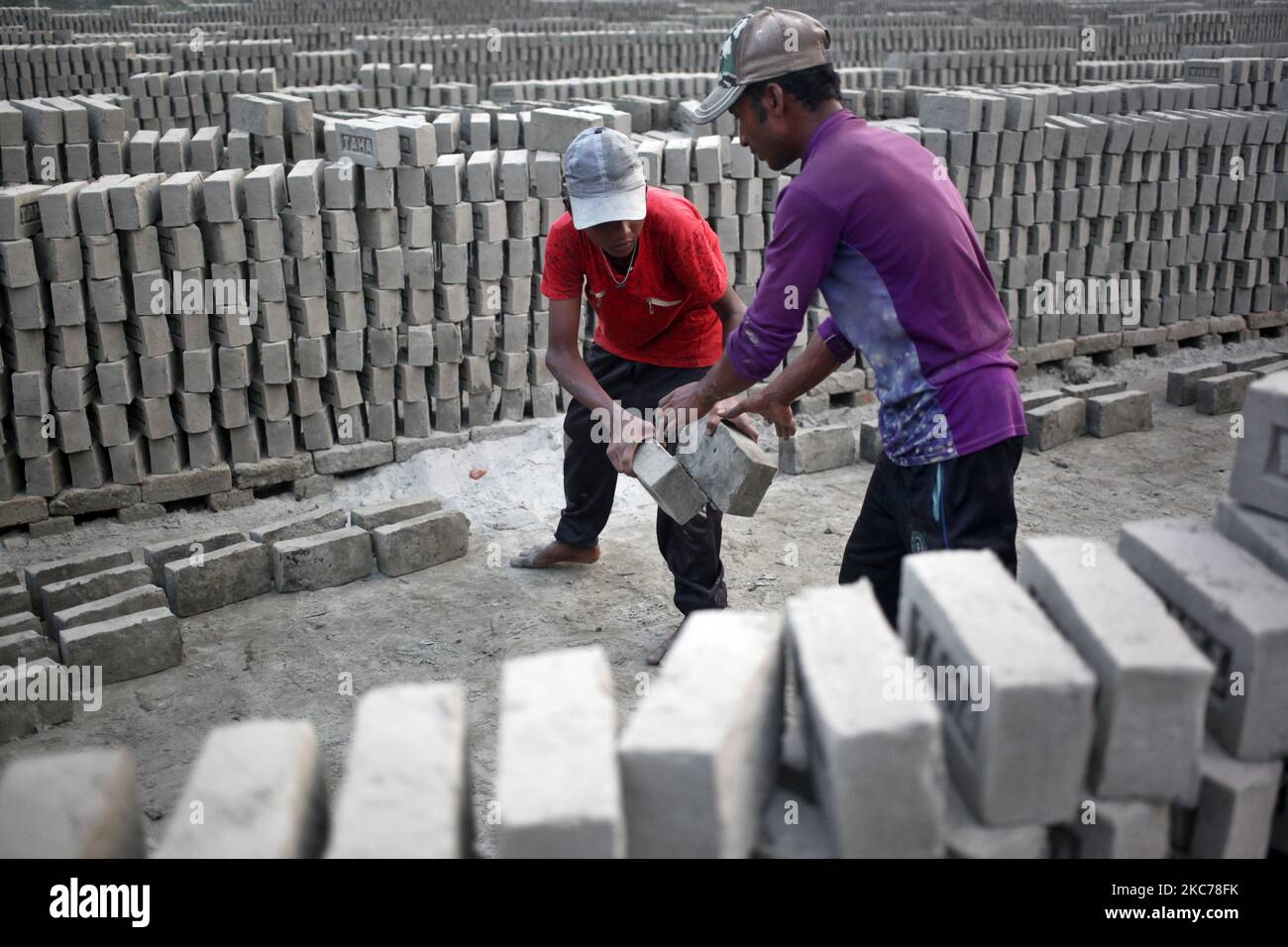 Laborers work at a brickfield in Dhaka, Bangladesh on Sunday, January ...