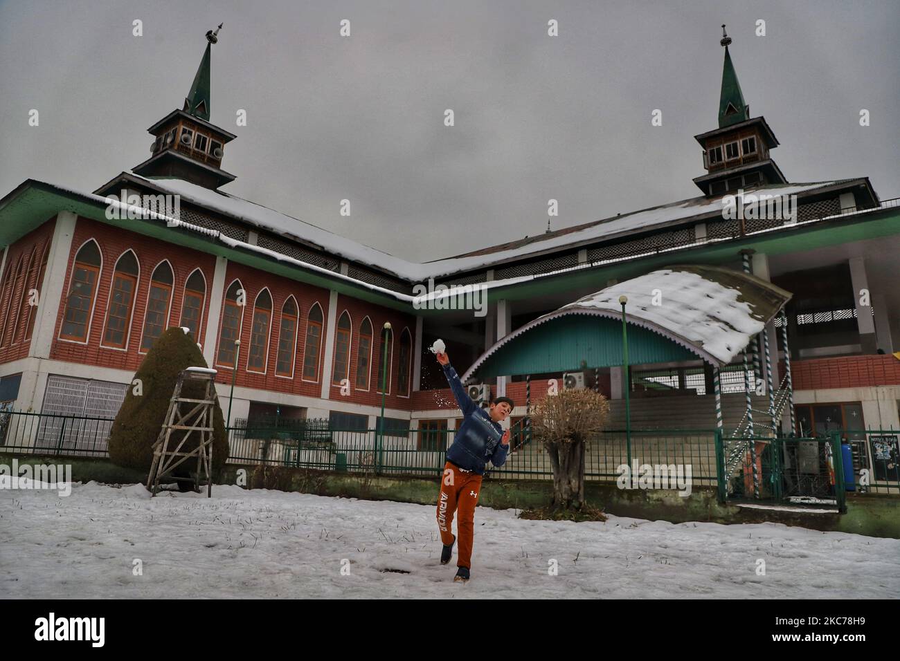 Kashmiri boys play with snow in the compound of Jama Masjid in Sopore ...