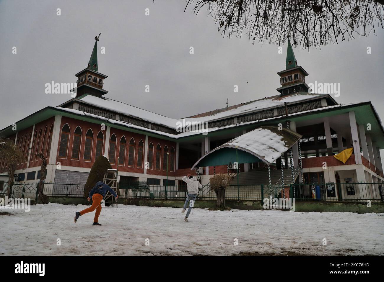Kashmiri boys play with snow in the compound of Jama Masjid in Sopore ...
