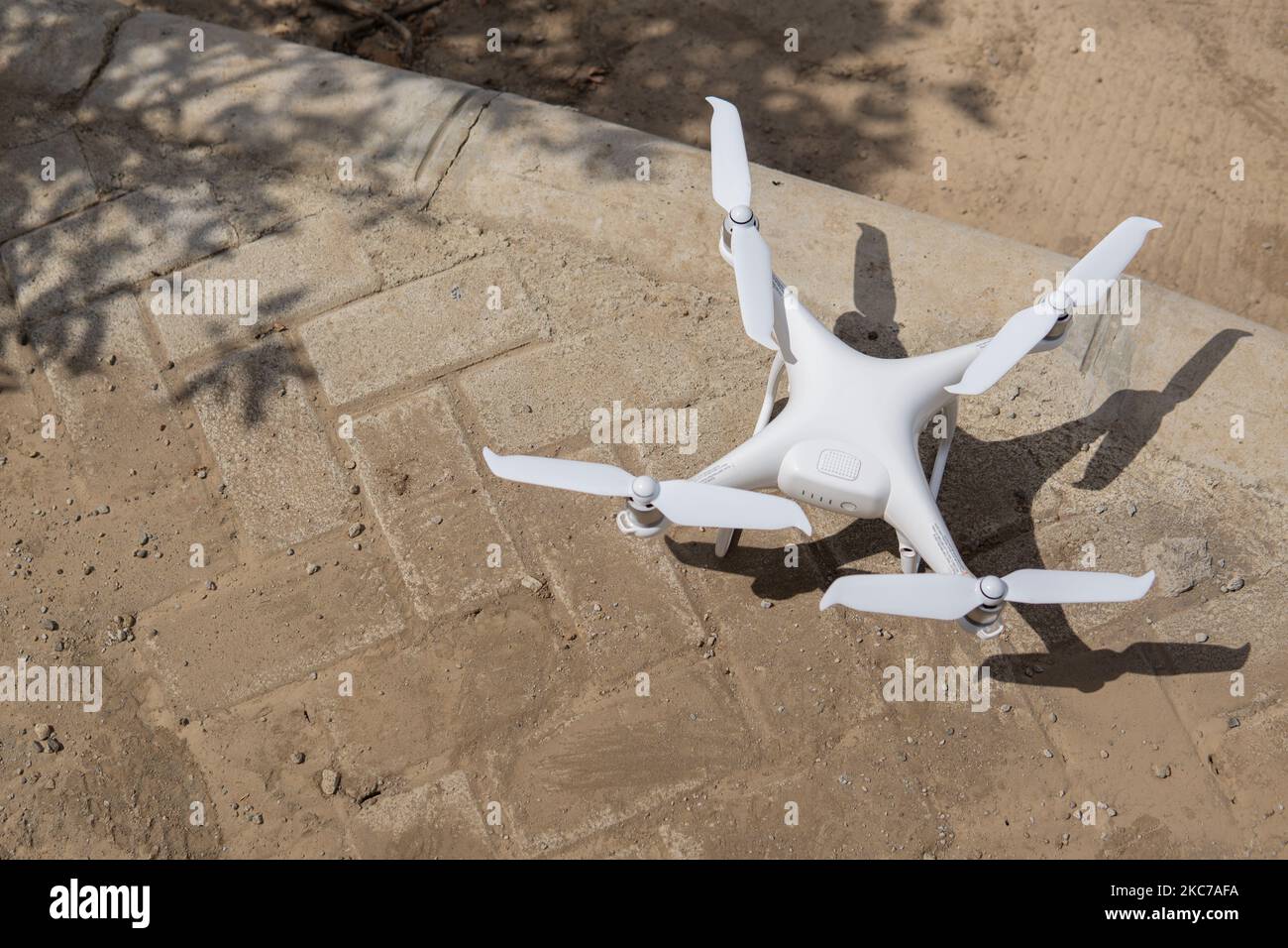 A white drone laying on the ground in sunlight Stock Photo - Alamy