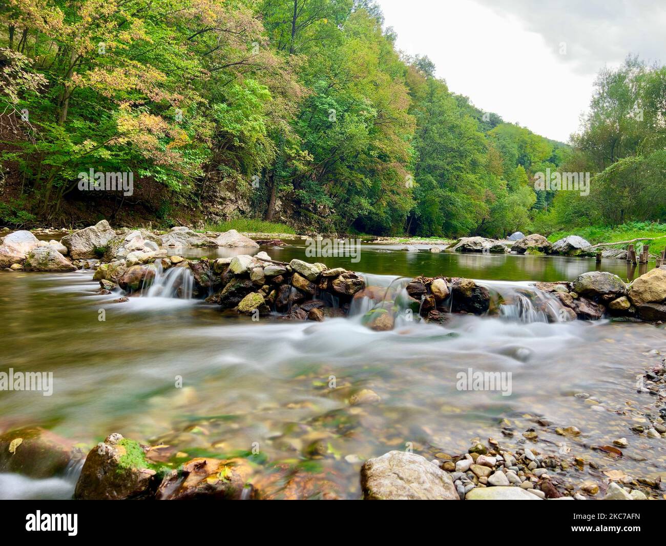 Beautiful river and small waterfall in green automn nature forrest with ...