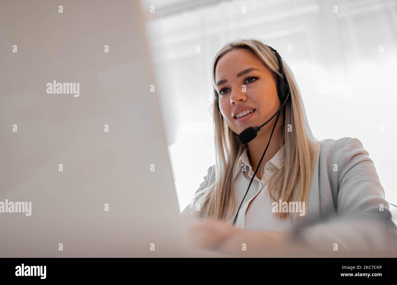Young woman working in call center. Customer support woman in office ...