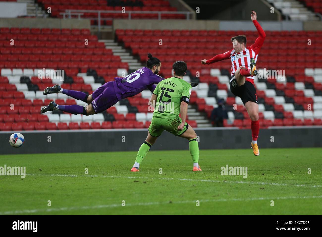 Dino Visser of Port Vale and Lynden Gooch of Sunderland miss a cross ...