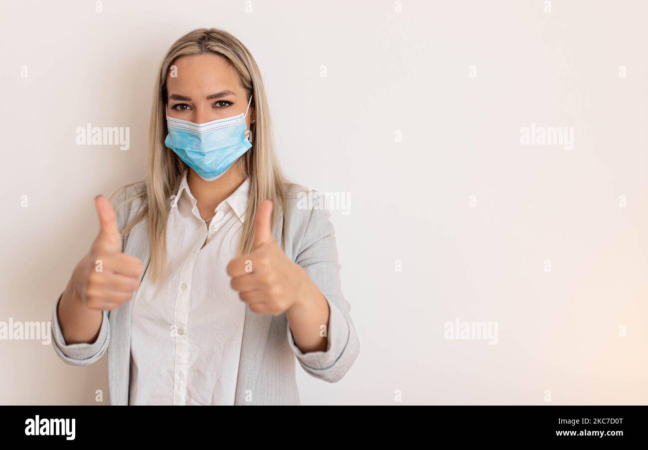 Beautiful caucasian young woman with disposable face mask. Protection ...