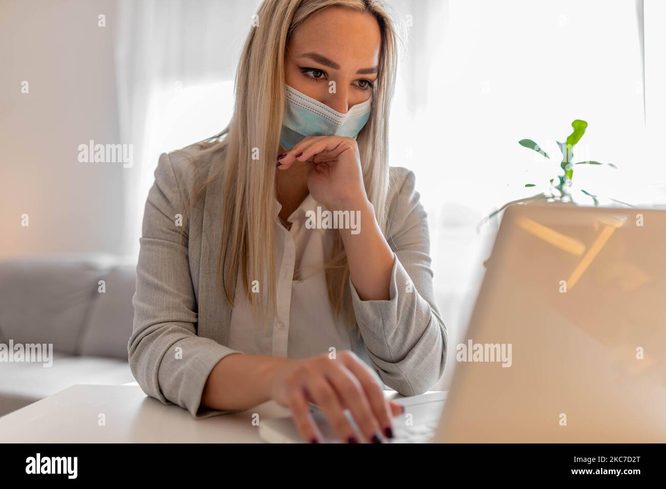 Female employee wearing medical face mask while working in the business ...