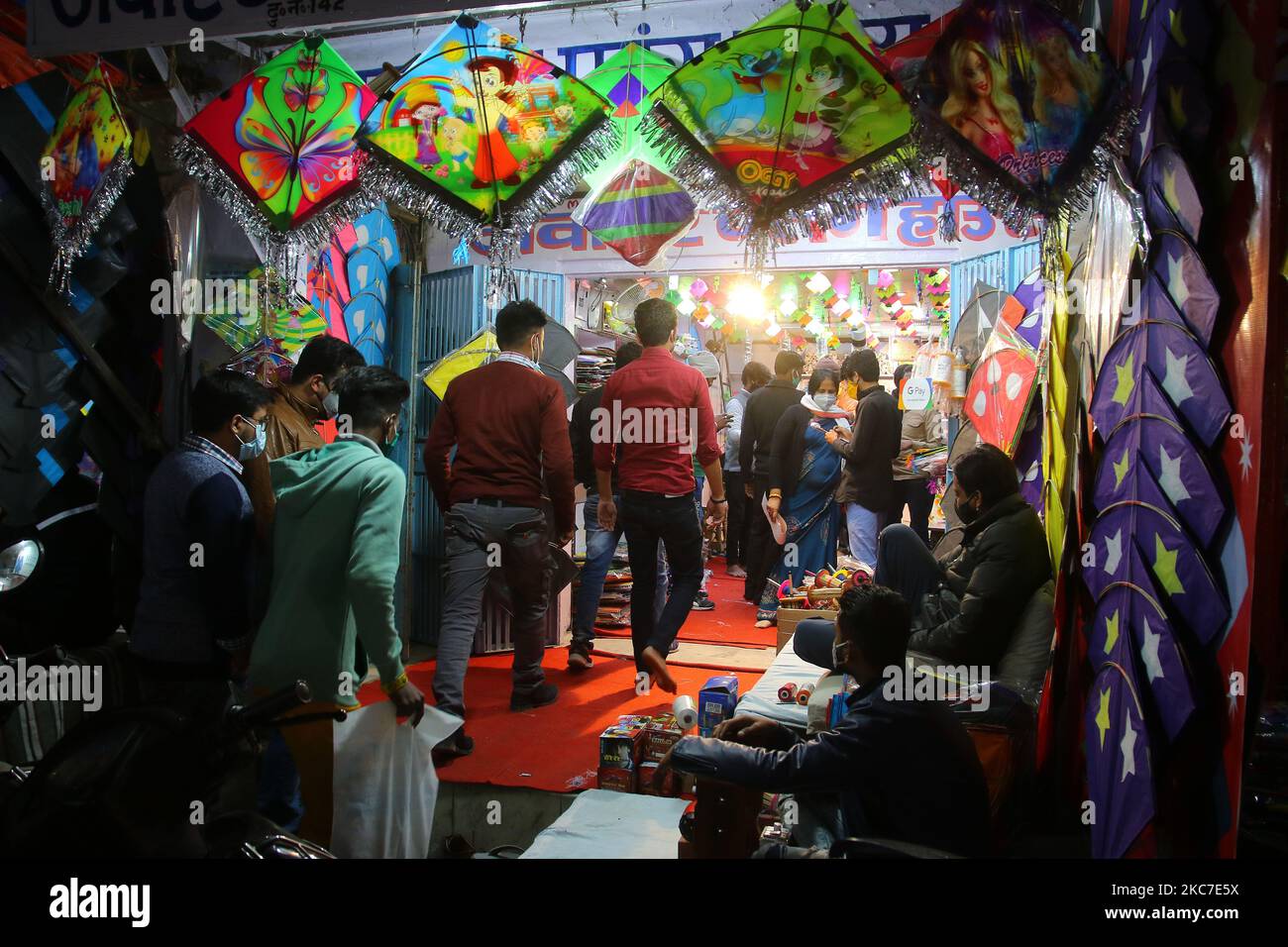People buy kites at a shop ahead of the Makar Sankranti festival at ...