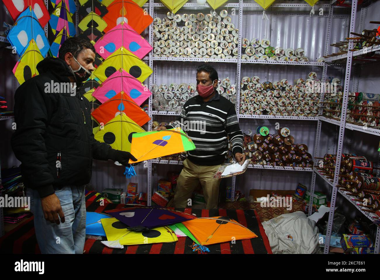 People buy kites at a shop ahead of the Makar Sankranti festival at ...