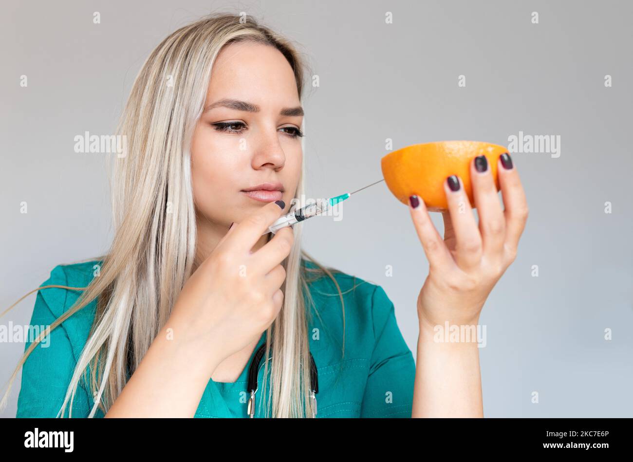 Scientist putting new sample to fruit. Female scientist injects the ...