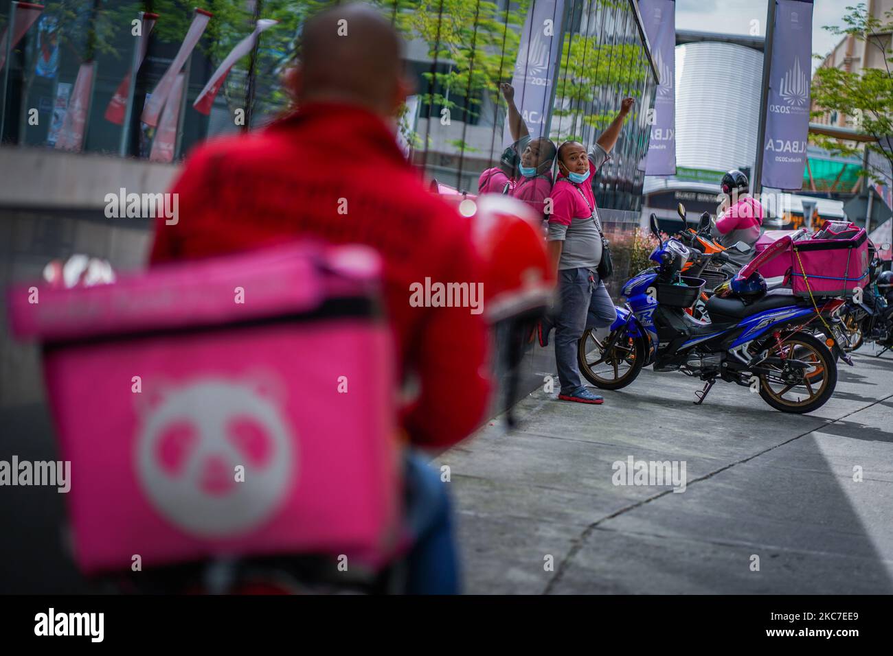 Foodpanda delivery rider wearing a protective mask waiting for order ...