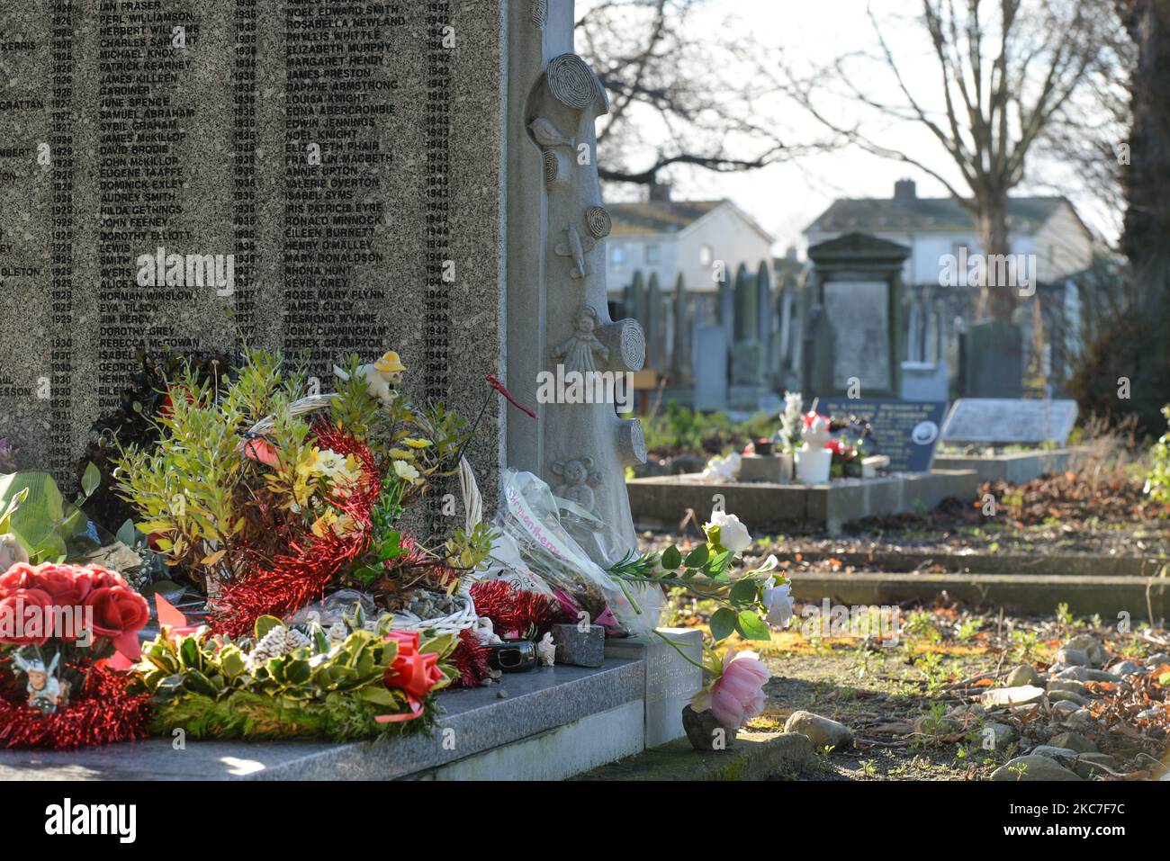 Figurines and flowers seen at the memorial commemorating more than 200 ...