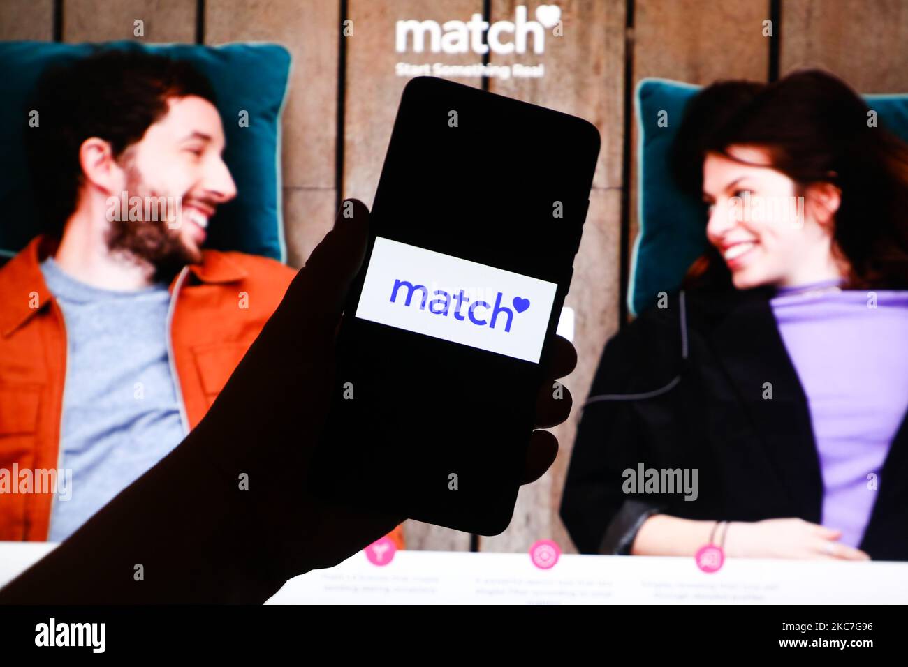 Match app logo is displayed on a mobile phone screen photographed on ...