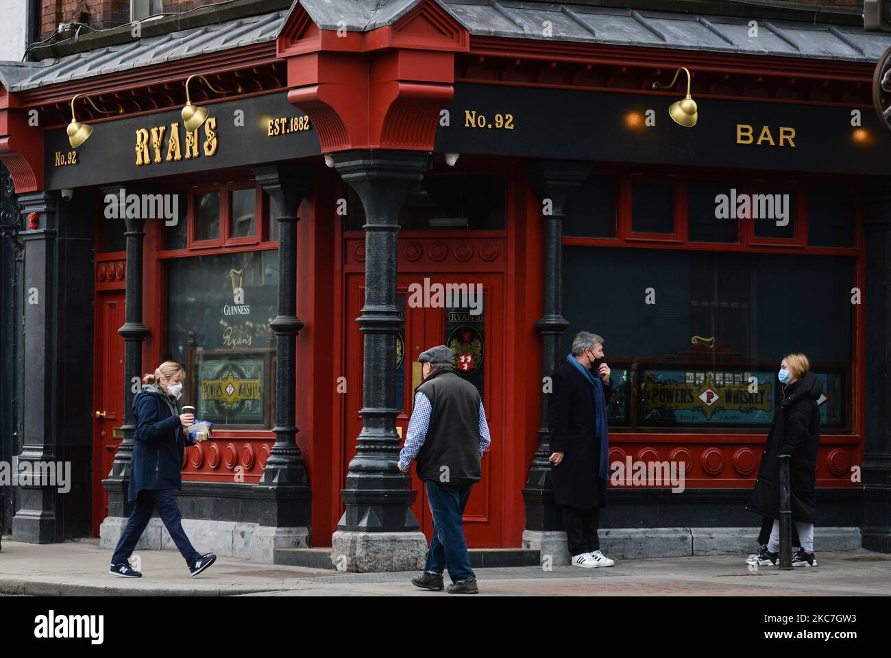 People seen outside a closed Ryans Bar seen in Dublin city center ...