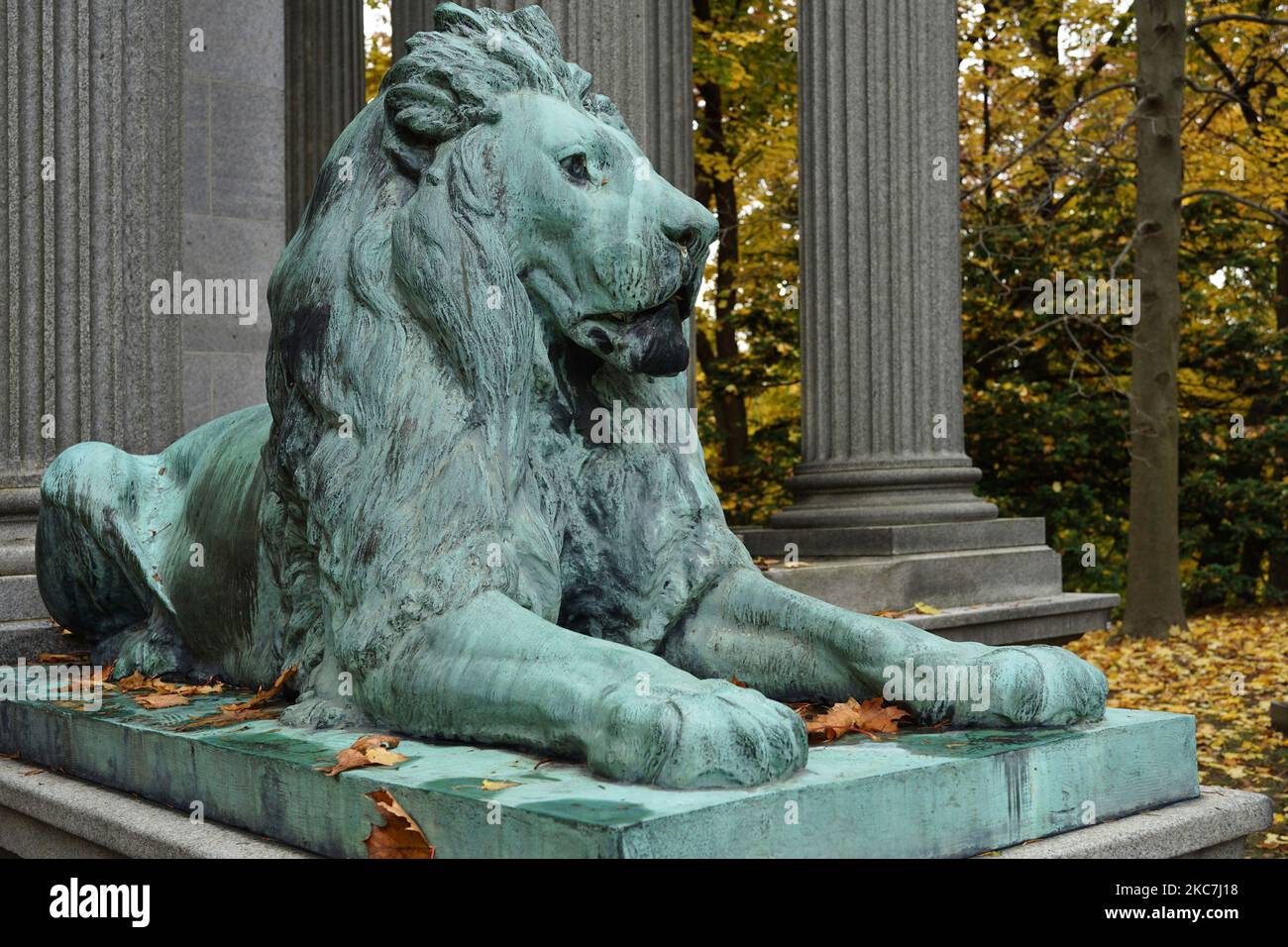 Bronze lion in a reclinining pose Stock Photo - Alamy