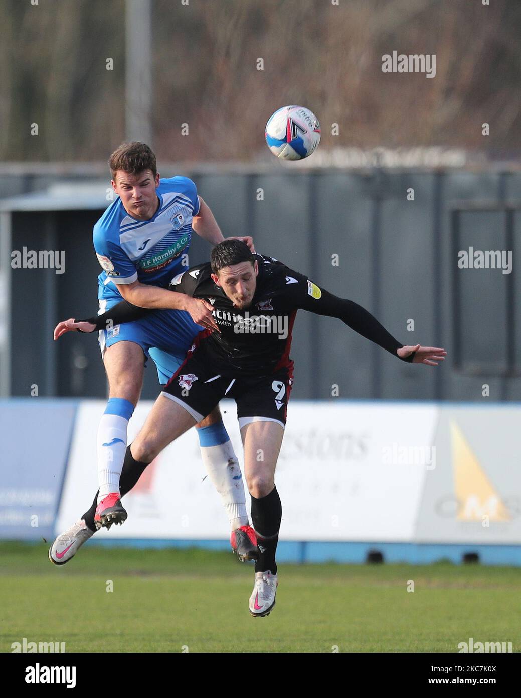 Matthew Platt of Barrow contests a header with Ryan Loft of Scunthorpe ...