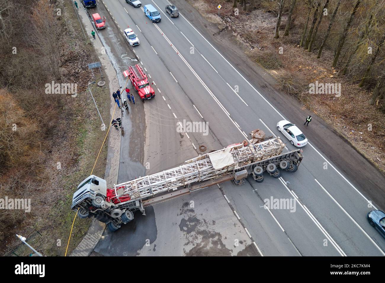 Aerial view of road accident with overturned truck blocking traffic ...