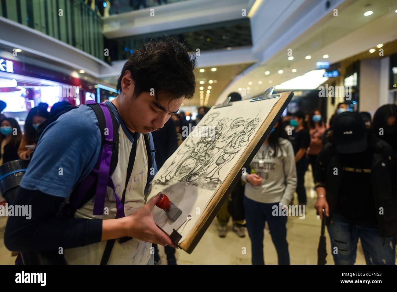 A protest artist stamps a sketch he realized during a protest in Yoho ...