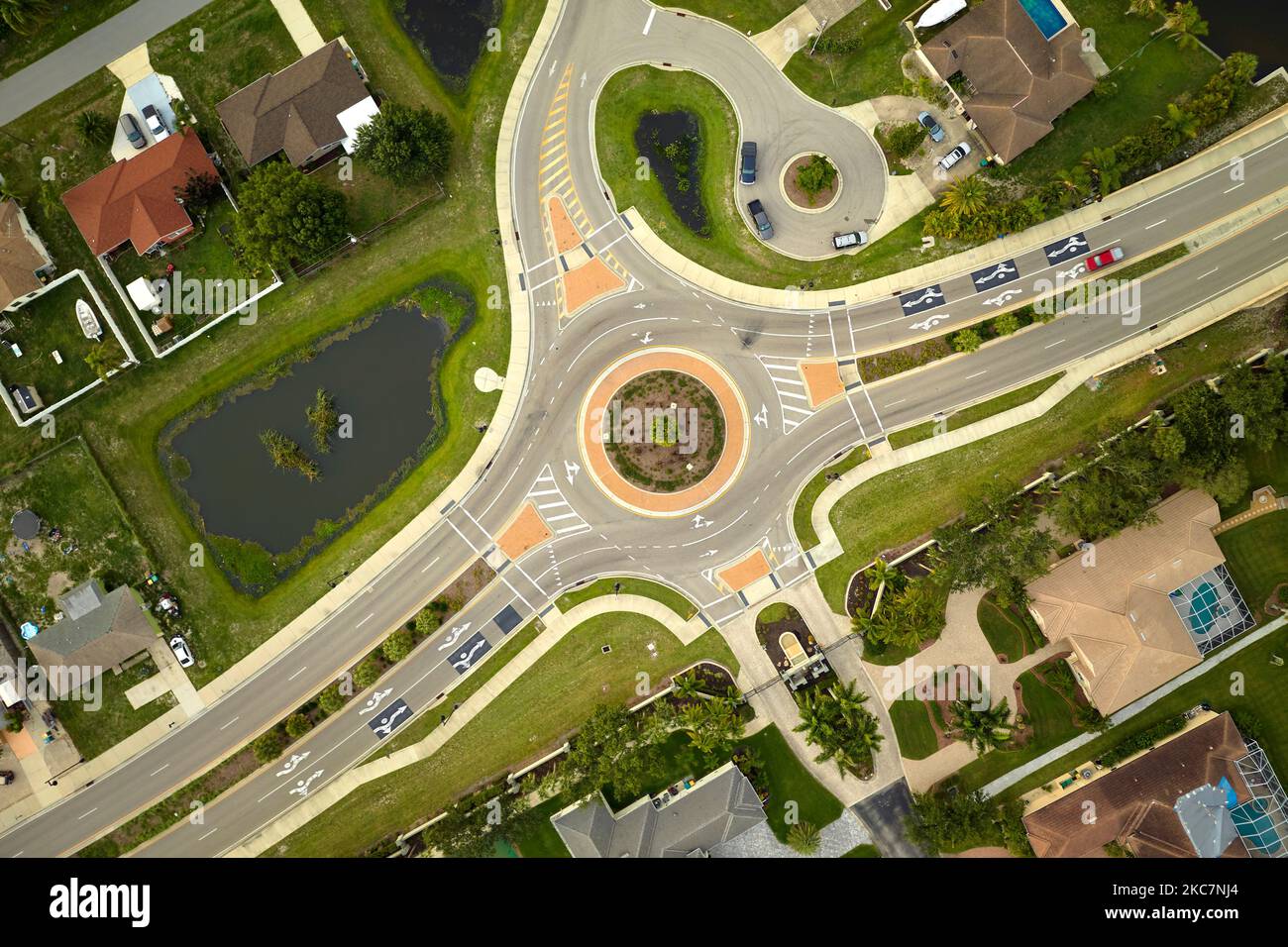 Aerial view of road roundabout intersection with moving cars traffic ...