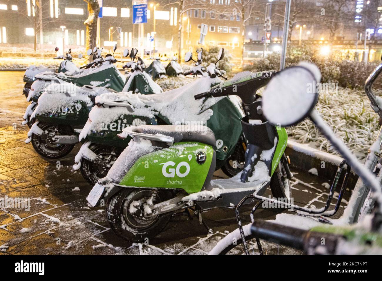 Snow covered electric scooters of GO sharing and Felyx companies ...