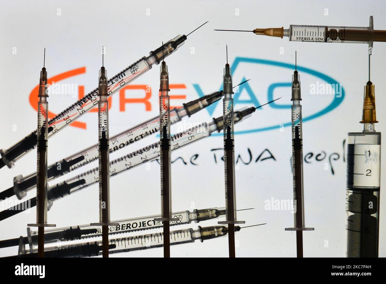 An illustrative image of medical syringes in front of CureVac logo ...