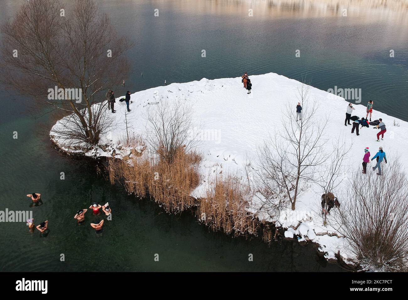 An aerial view on winter swimmers dipping in cold water of Zakrzowek ...