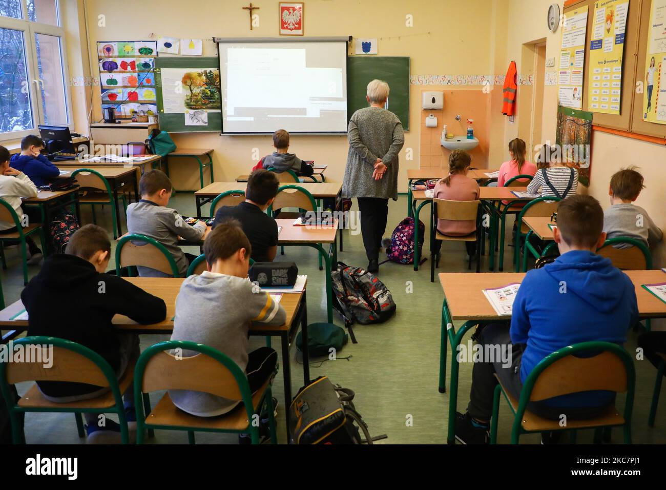 Pupils and a teacher attend classes on the first day of the reopening ...