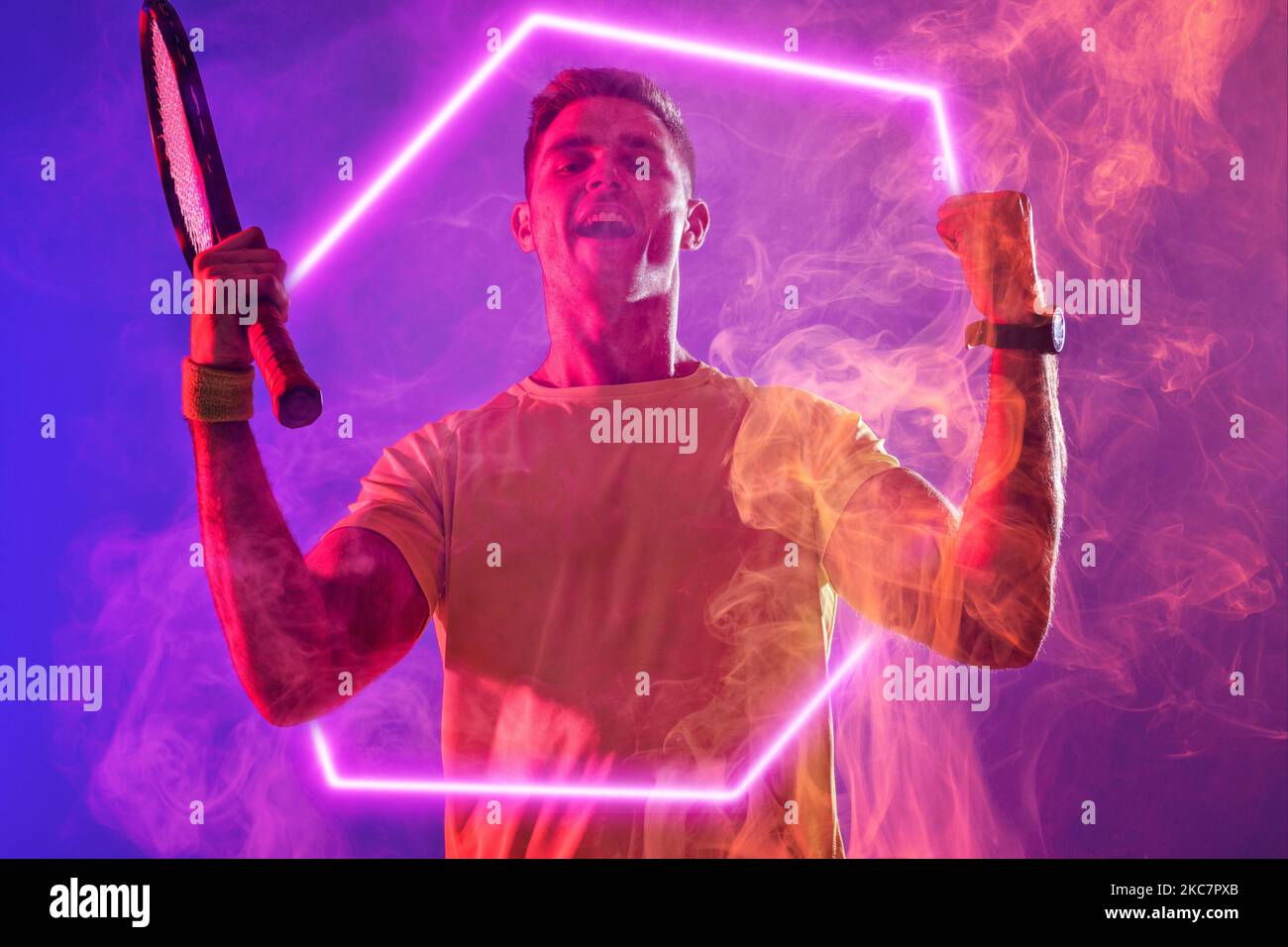 Portrait of caucasian male tennis player holding racket and screaming ...