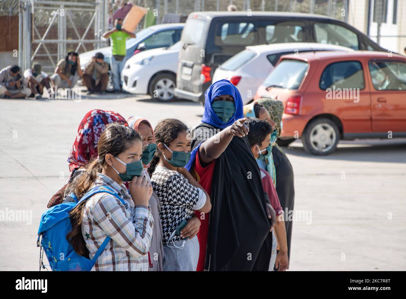 Women and girls wearing facemasks are waiting seperately from men to get food. Humanitarian Aid ...
