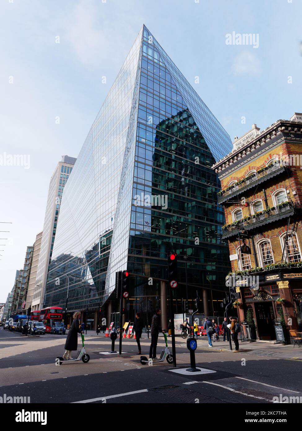 People on scooters at a pedestrian crossing on Victoria Street with a ...