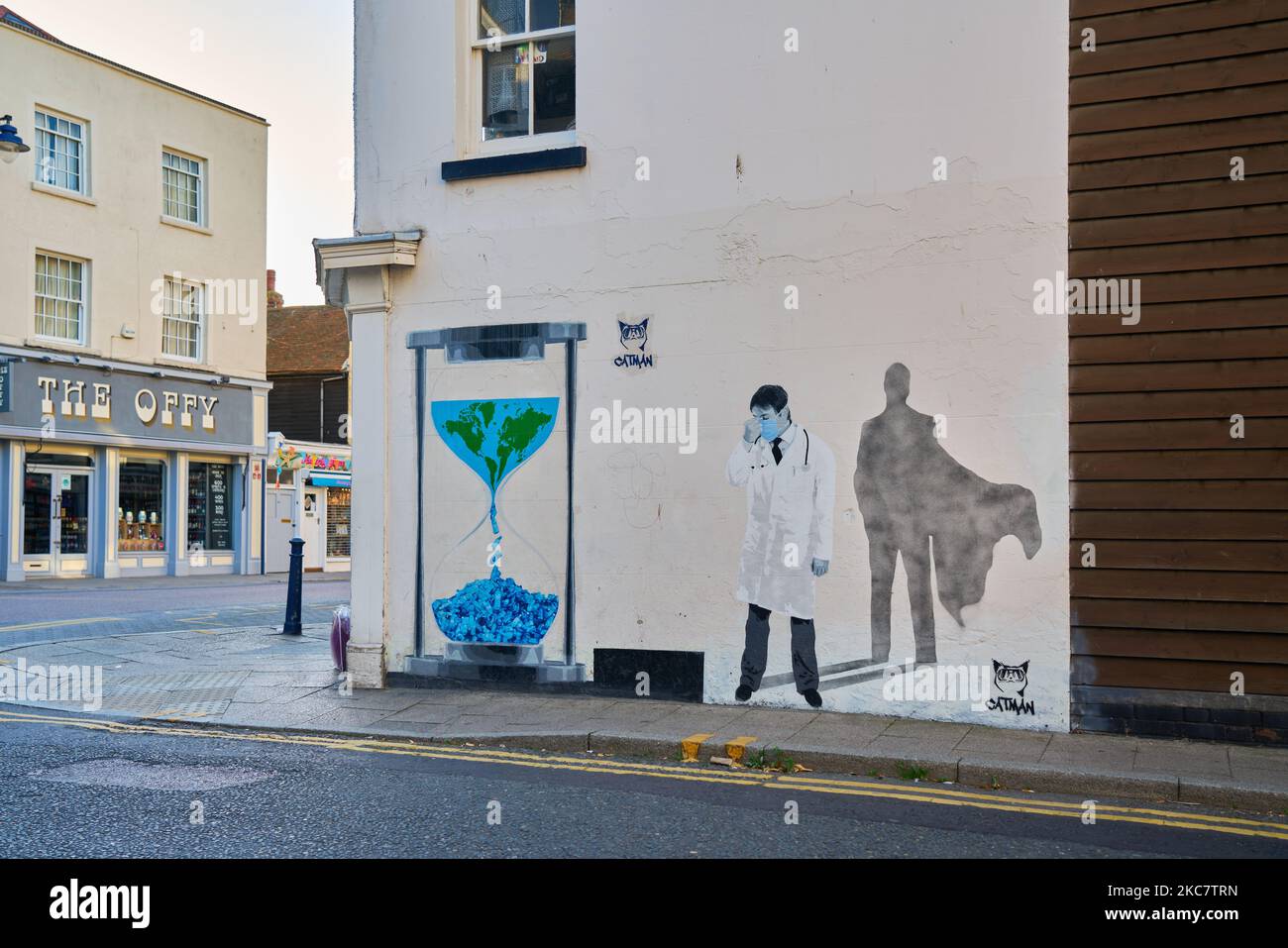 A Wall Mural of the earth is an hourglass with a doctor wearing a mask ...