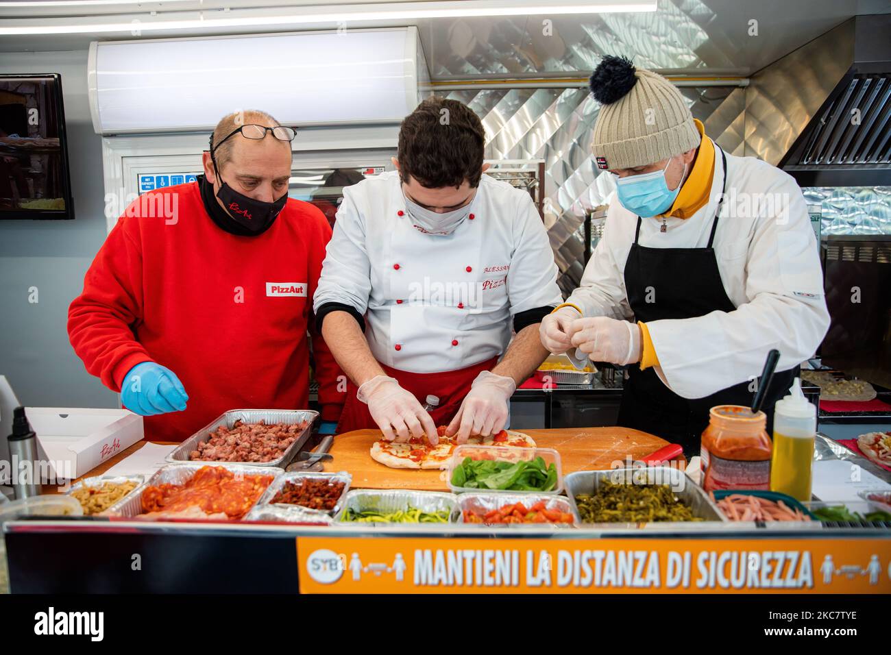 The staff of PizzAut, pizzeria run by autistic guys, prepares and ...