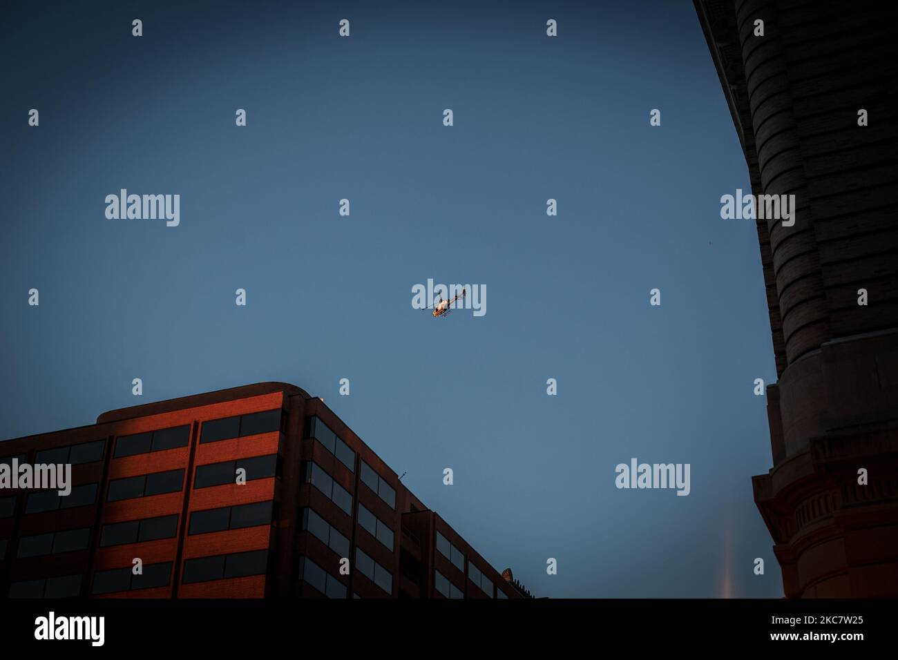 A MPD helicopter flys low overhead the red and green zone areas of ...