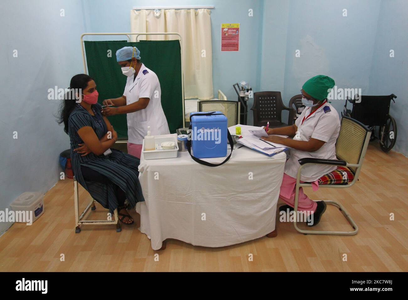 A medical staff member inoculates a woman with COVID-19 vaccine at the ...
