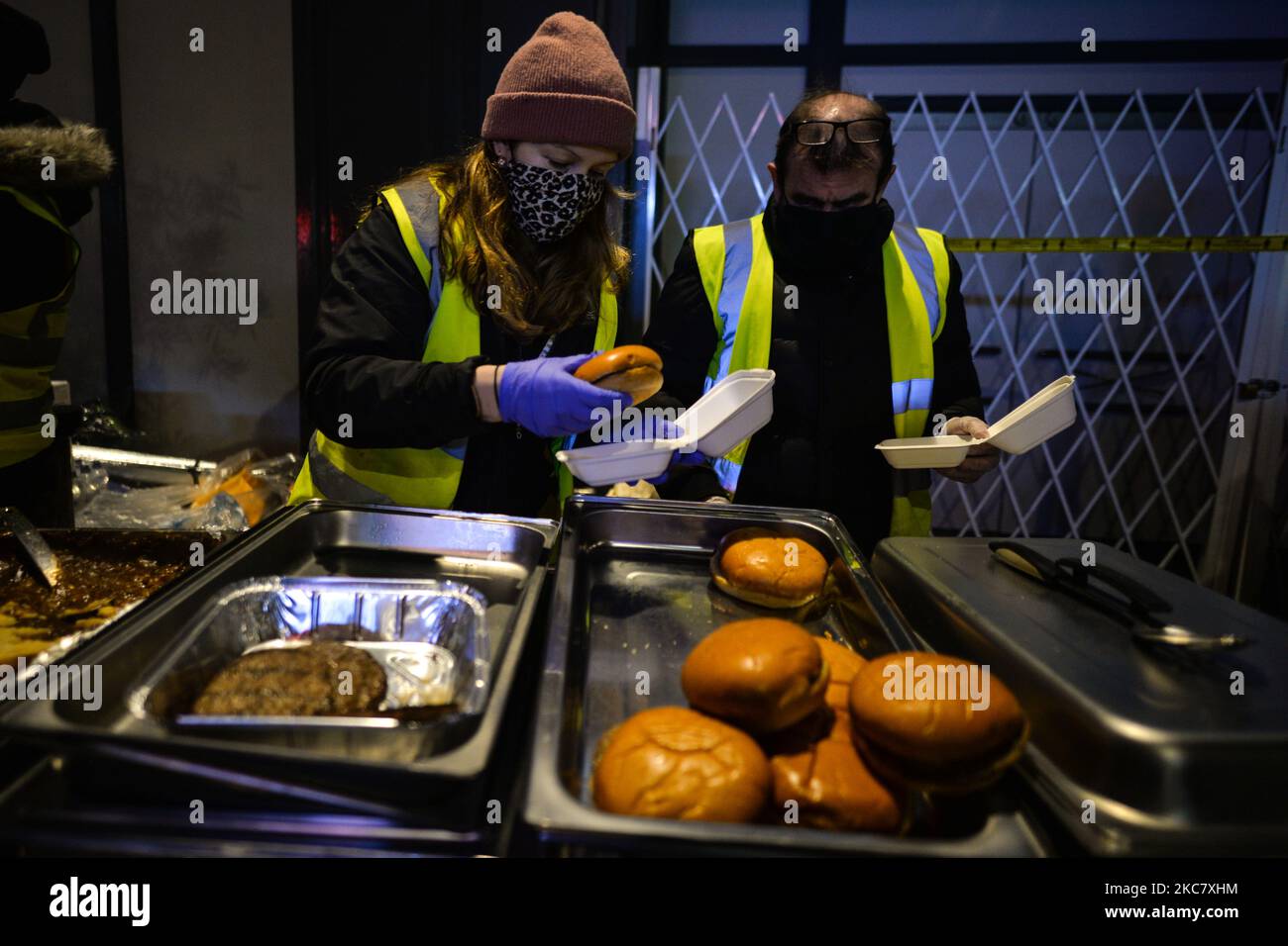 A group of volunteers from the Homeless Mobile Run distributing hot ...