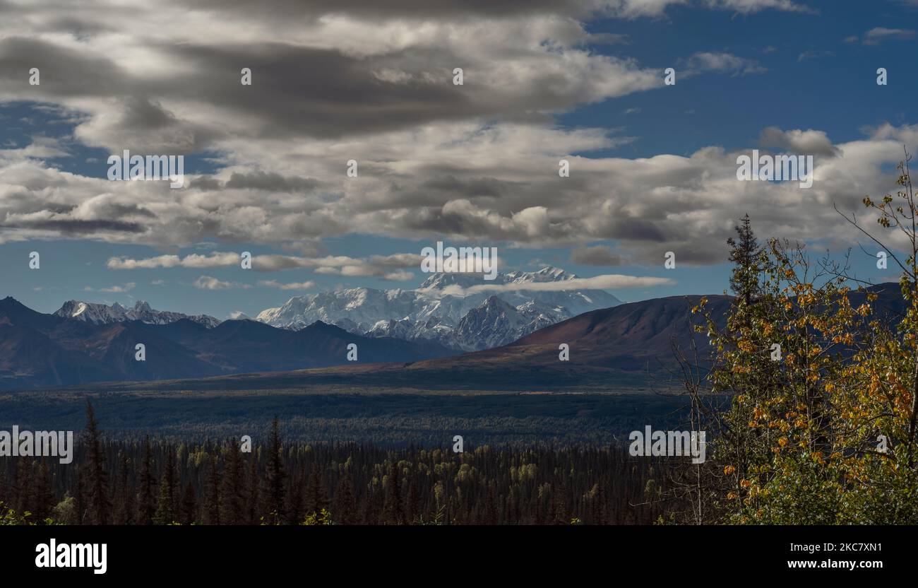 A scenic view of Denali mountain in Alaska in cloudy sky background ...