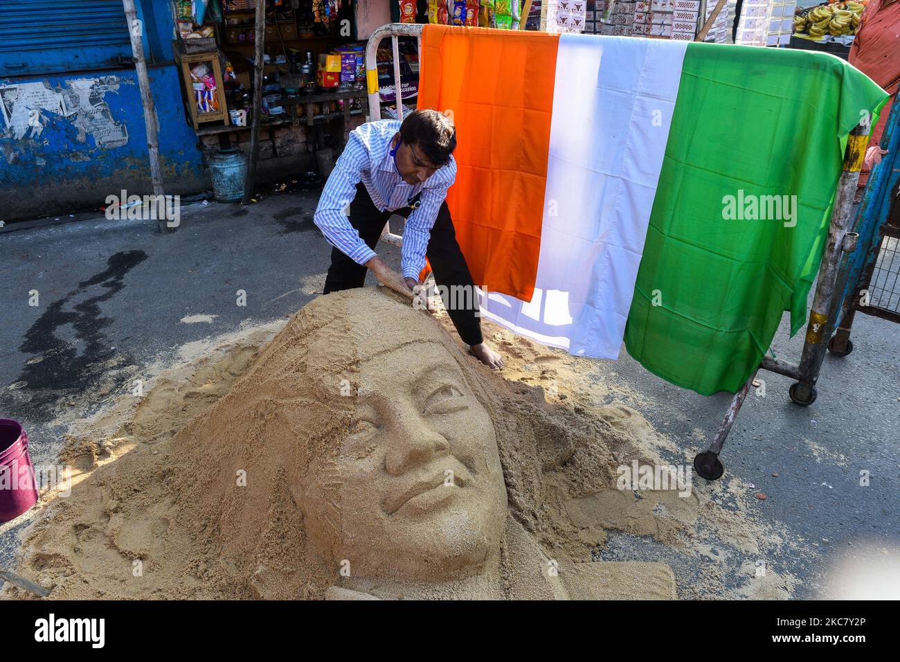 An artist gives final touches to a sand sculpture of Netaji Subhas ...
