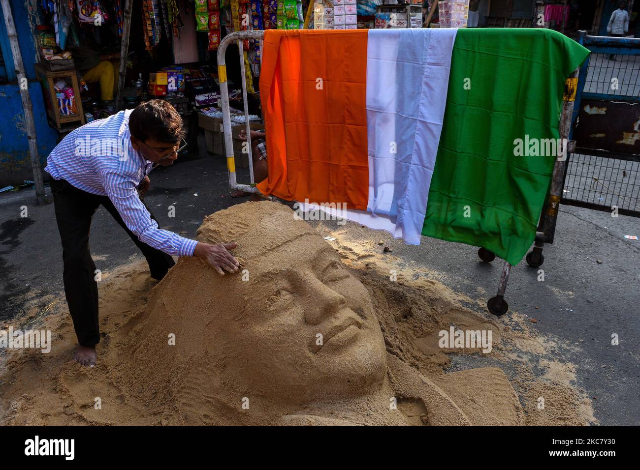 An artist gives final touches to a sand sculpture of Netaji Subhas ...